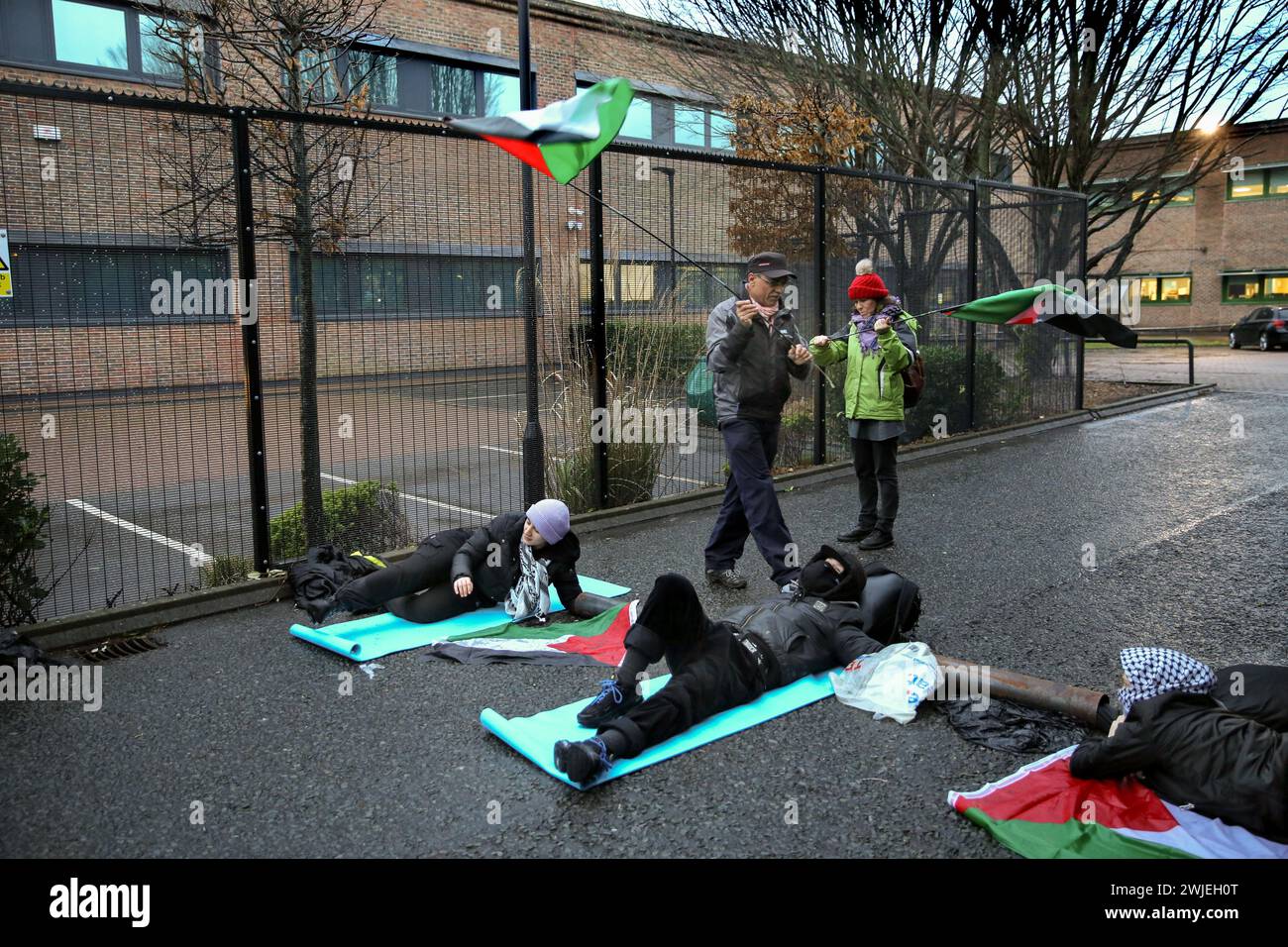 Protesters place themselves in a three-way lock-on, blocking the ...