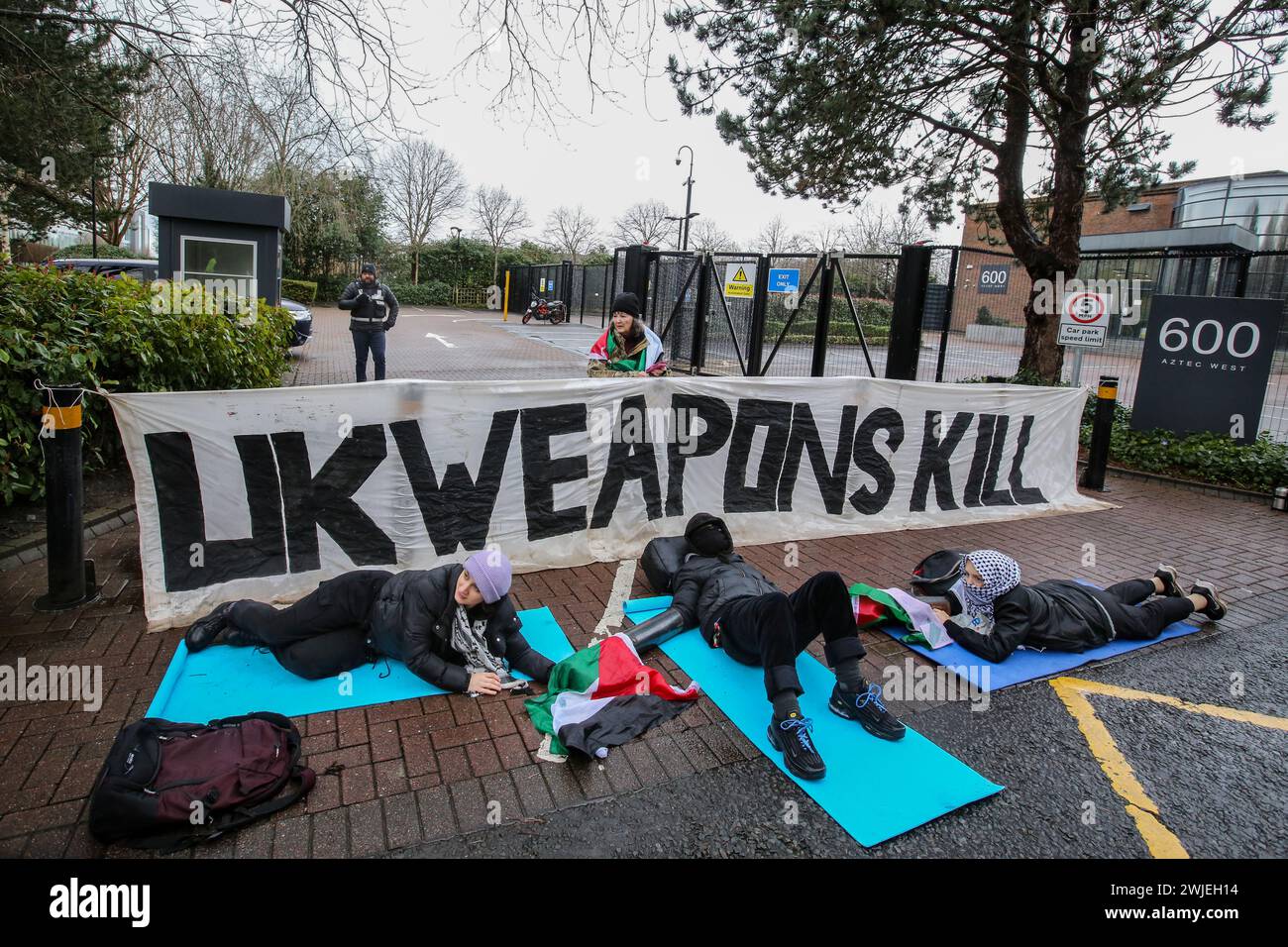 Protesters place themselves in a three-way lock-on, blocking the ...