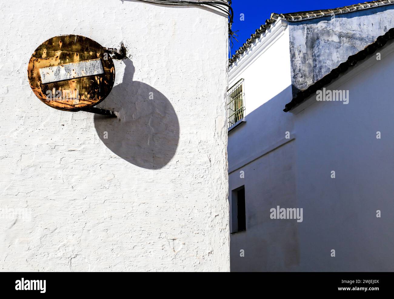 Old and rusty no entry road signal on white facade in Andalusia, Spain ...