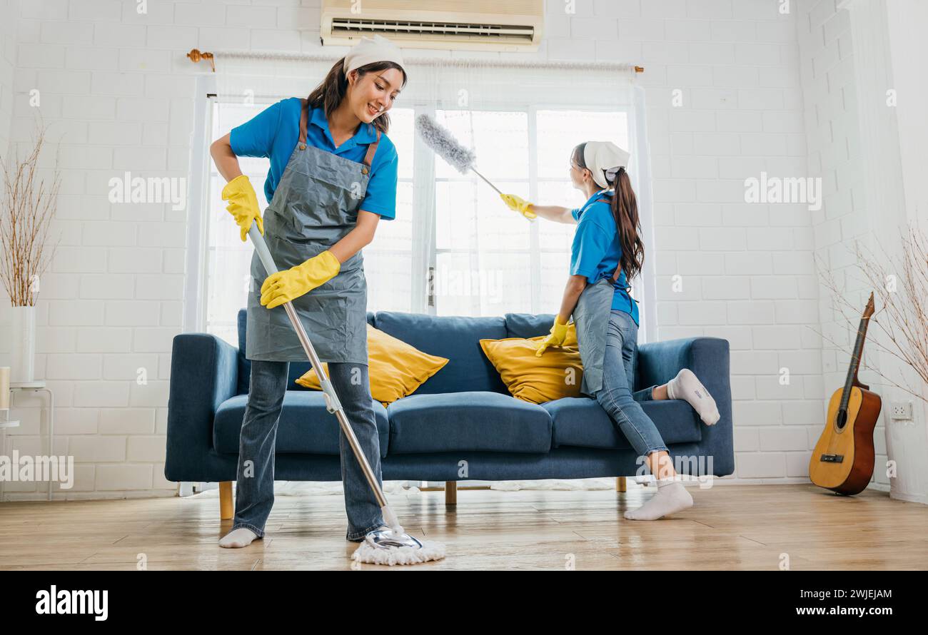 Women in gloves and uniforms employees of a cleaning service carefully ...