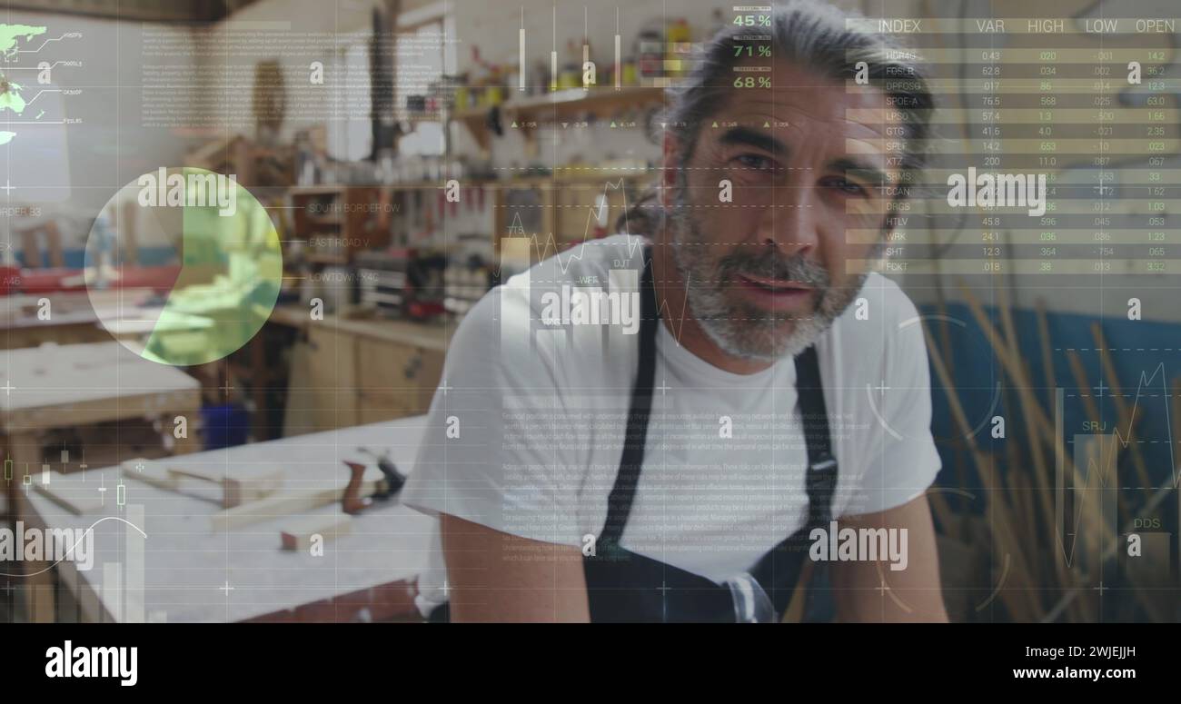 Two men building in a workshop with graphs and stats Stock Photo - Alamy