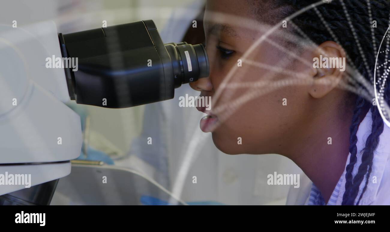 Image of dna strand over diverse doctors using microscope Stock Photo ...