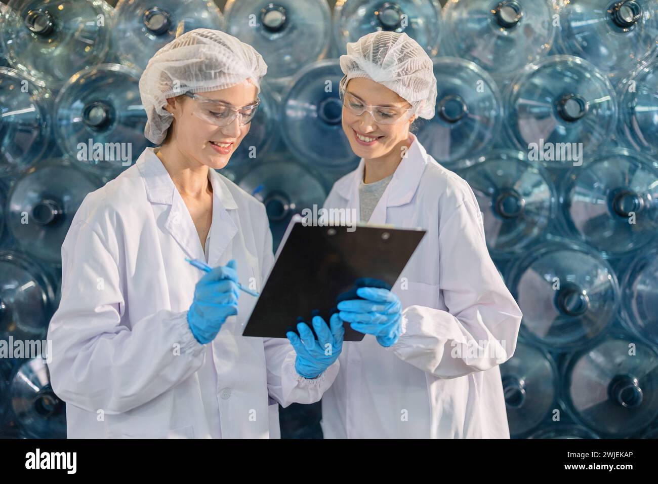 Product quality control team officer working together in drinking water ...