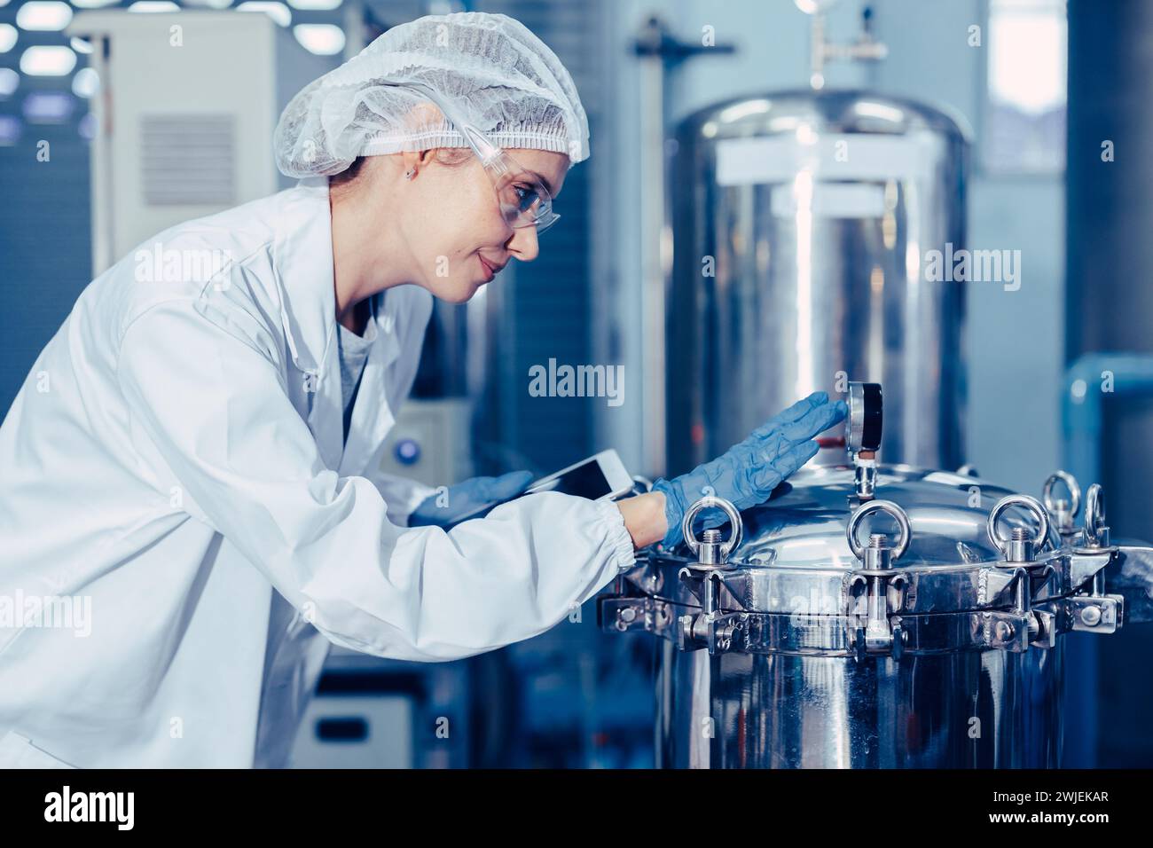 staff work in science medical lab factory check record pressure tank ...