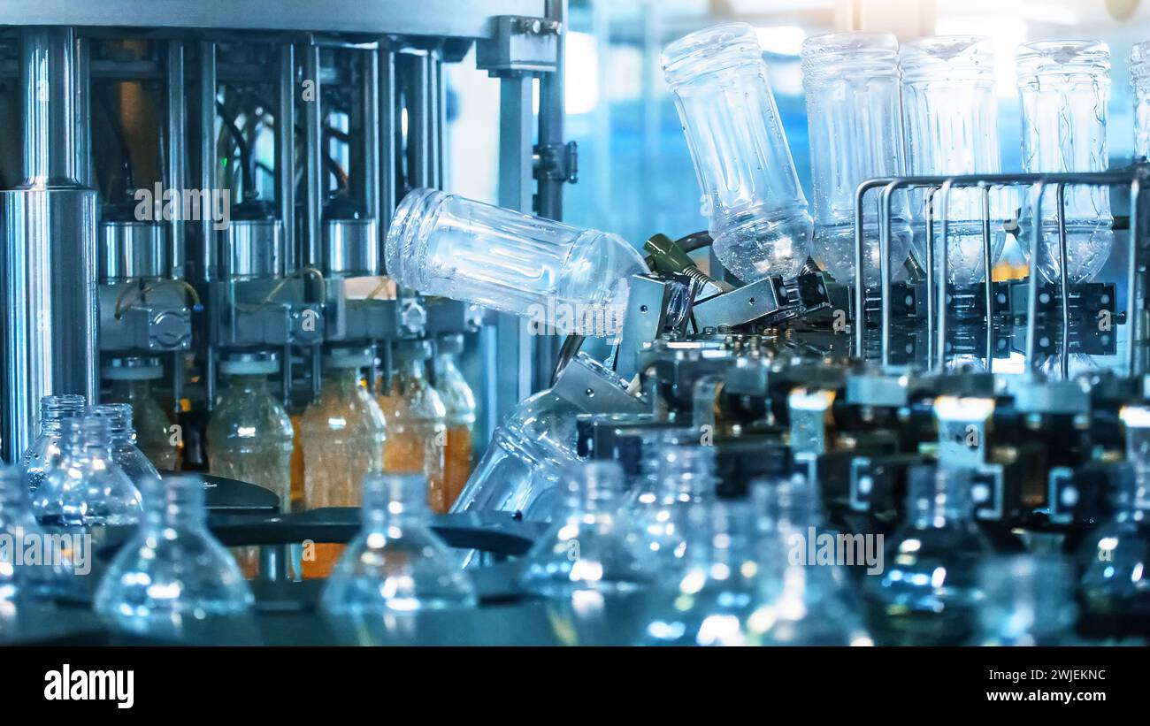 Process of filling plastic bottles inside industrial machine conveyor ...