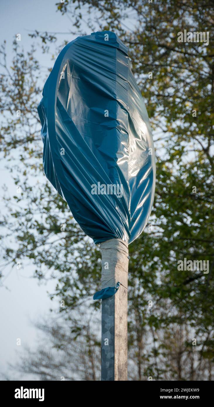 Plastic wrapped traffic sign Stock Photo - Alamy