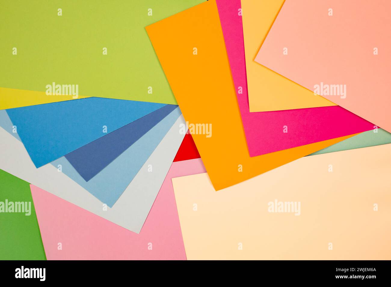 sheets of colored paper. Many colored sheets of paper are laid out in ...