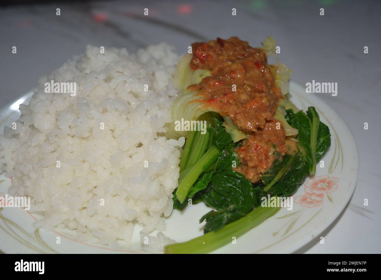 A plate of pecel rice, on a white background Stock Photo - Alamy