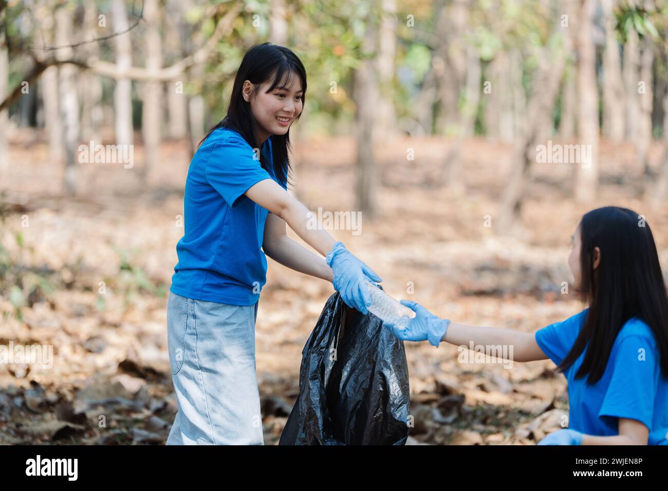 Group of volunteers, community members cleaning the nature from garbage ...