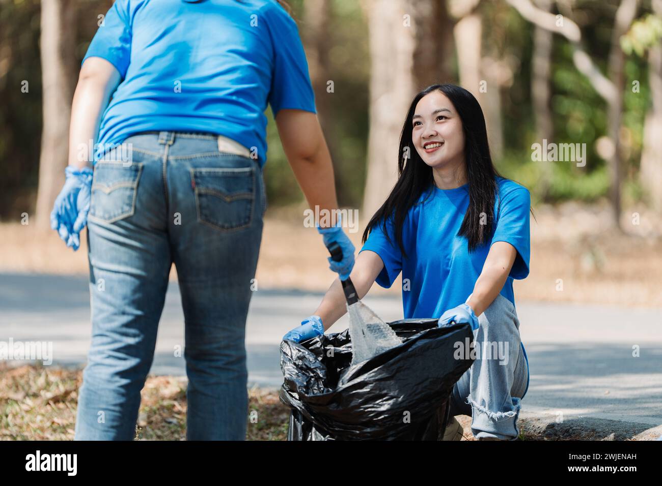 Group of volunteers, community members cleaning the nature from garbage ...