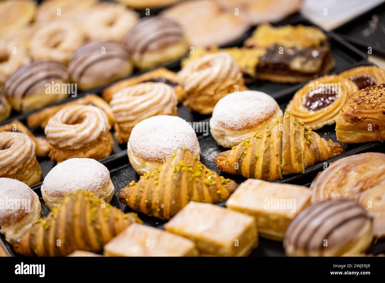 Berlin, Germany. 15th Feb, 2024. Pastries are lined up on a table ...