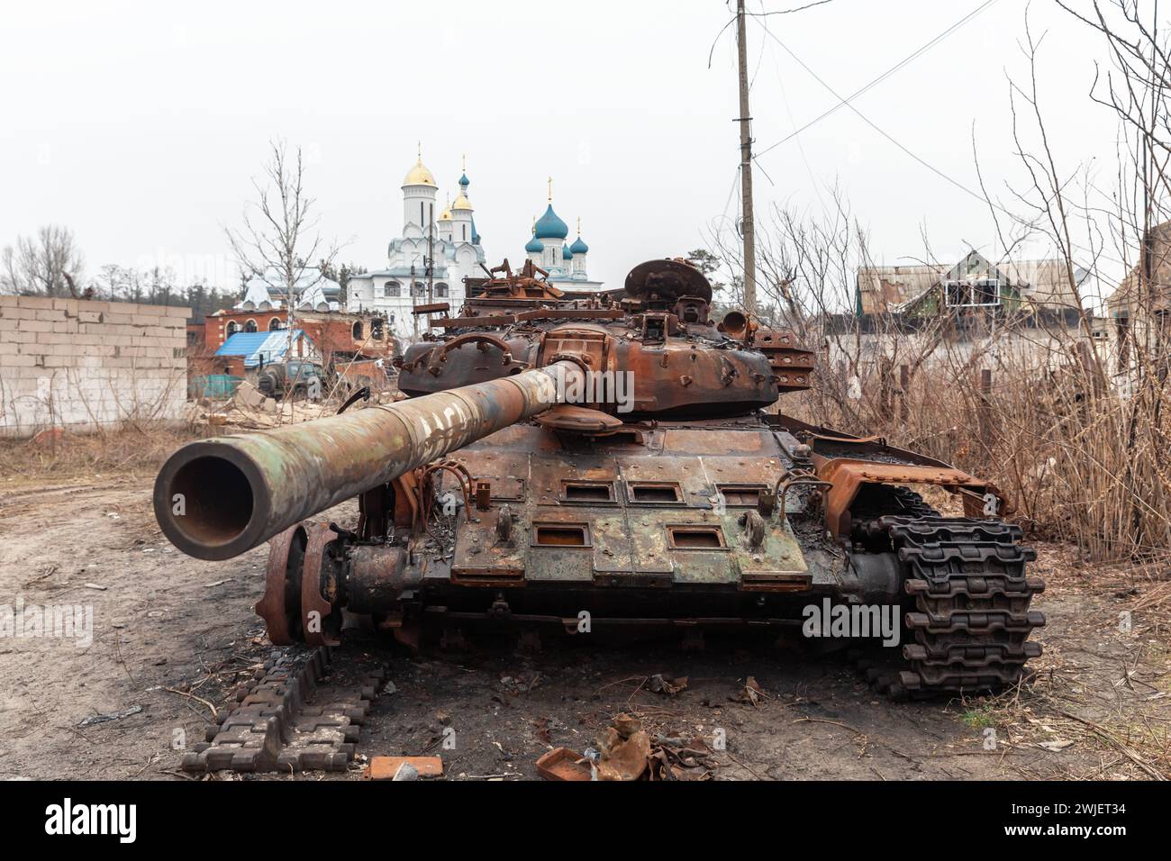 War in Ukraine. A burnt-out Russian tank is seen on the street of ...