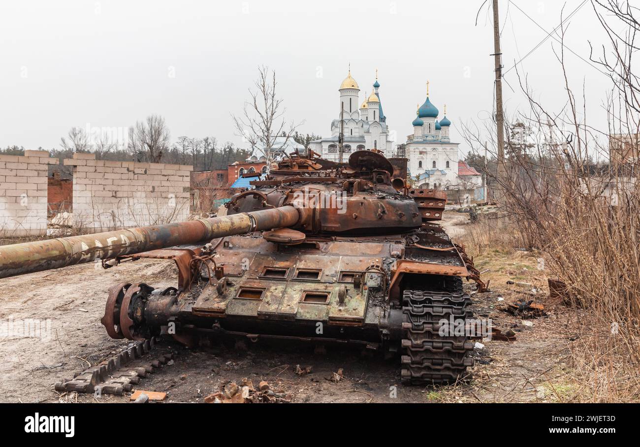 War in Ukraine. A burnt-out Russian tank is seen on the street of ...