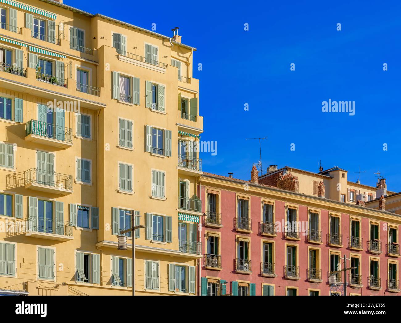 Looking up at chic apartments overlooking Port Lympia in Nice, on the ...