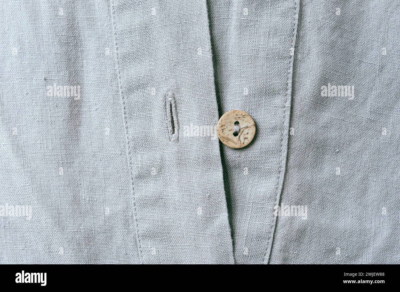Close up coconut button on grey linen dress Stock Photo - Alamy