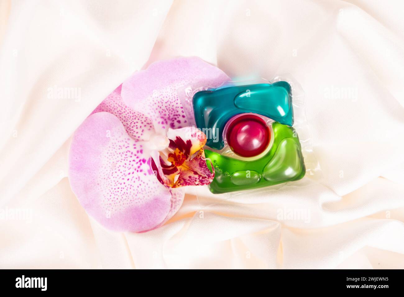 Gel liquid laundry detergent capsule with floral scent with orchid ...