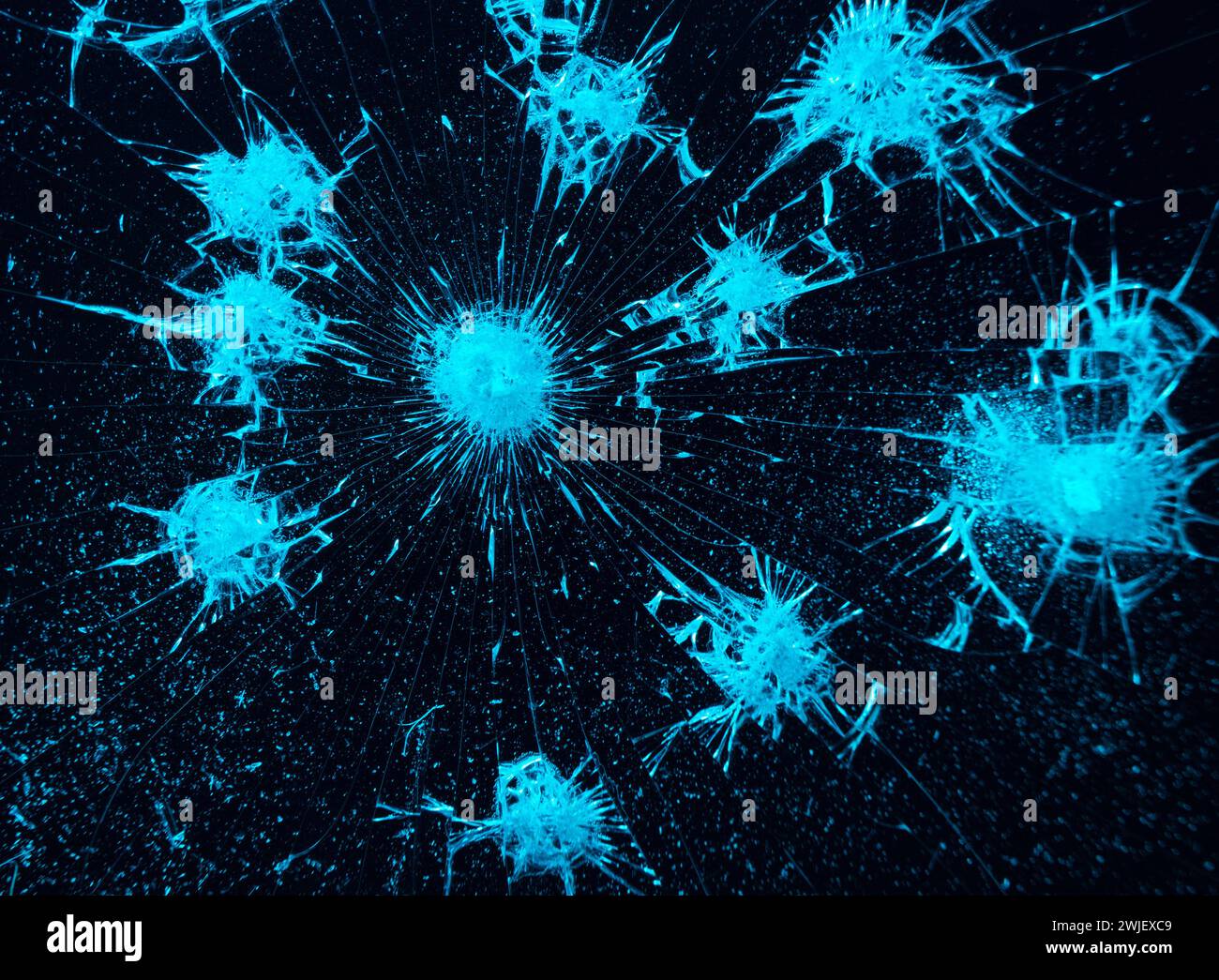 Set of blue cracks in window on black background. Broken glass texture ...