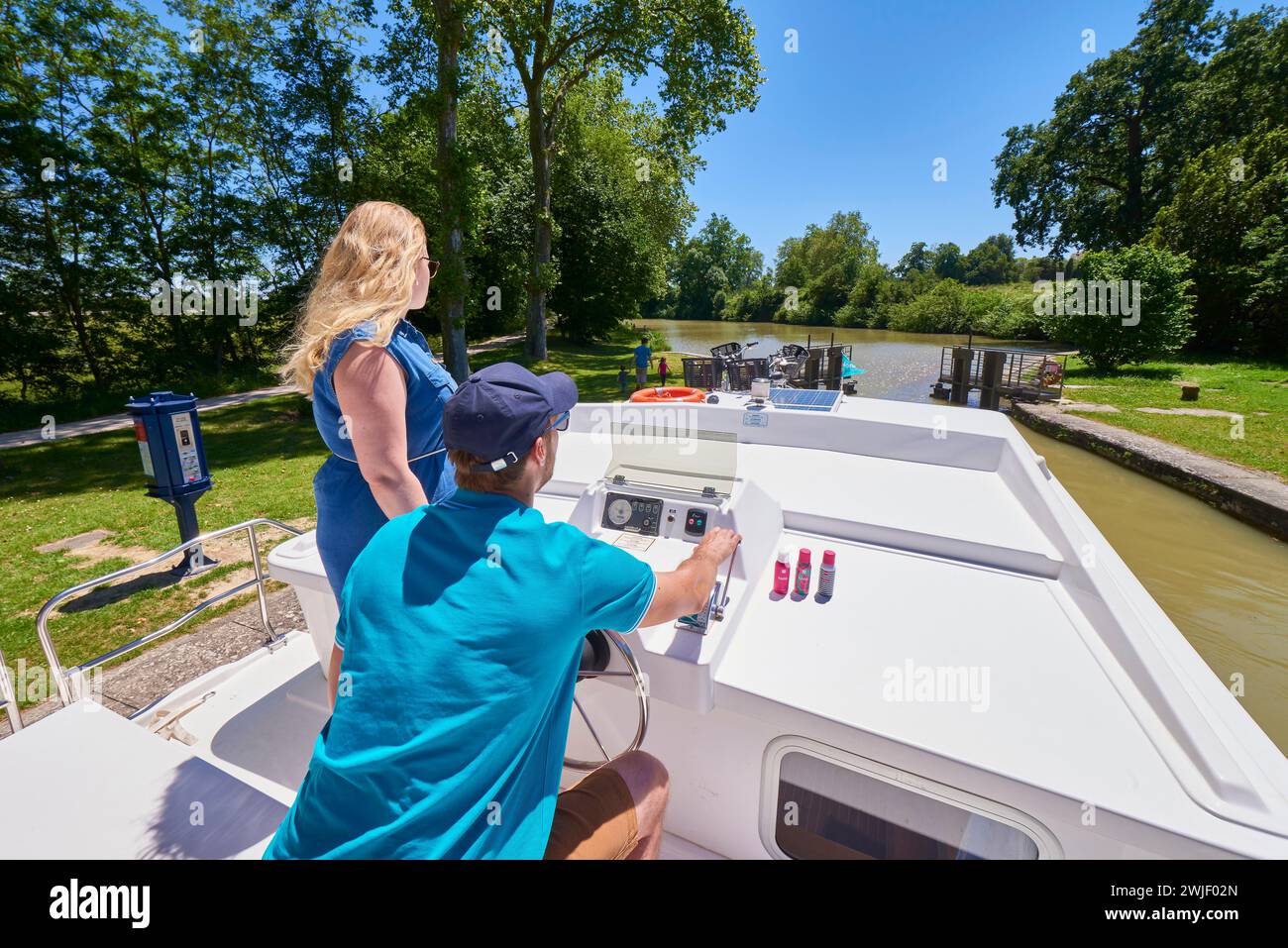 Young Couple Cruising On The Canal Du Midi Passing Through A Lock The