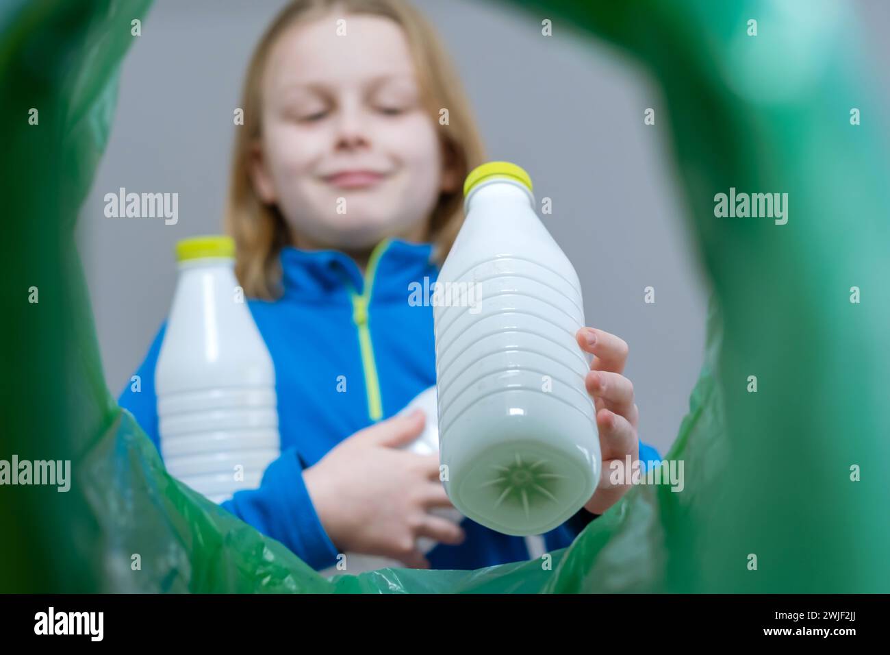 Low angle view a child sorting plastic recycle bin in home. Sustainable ...