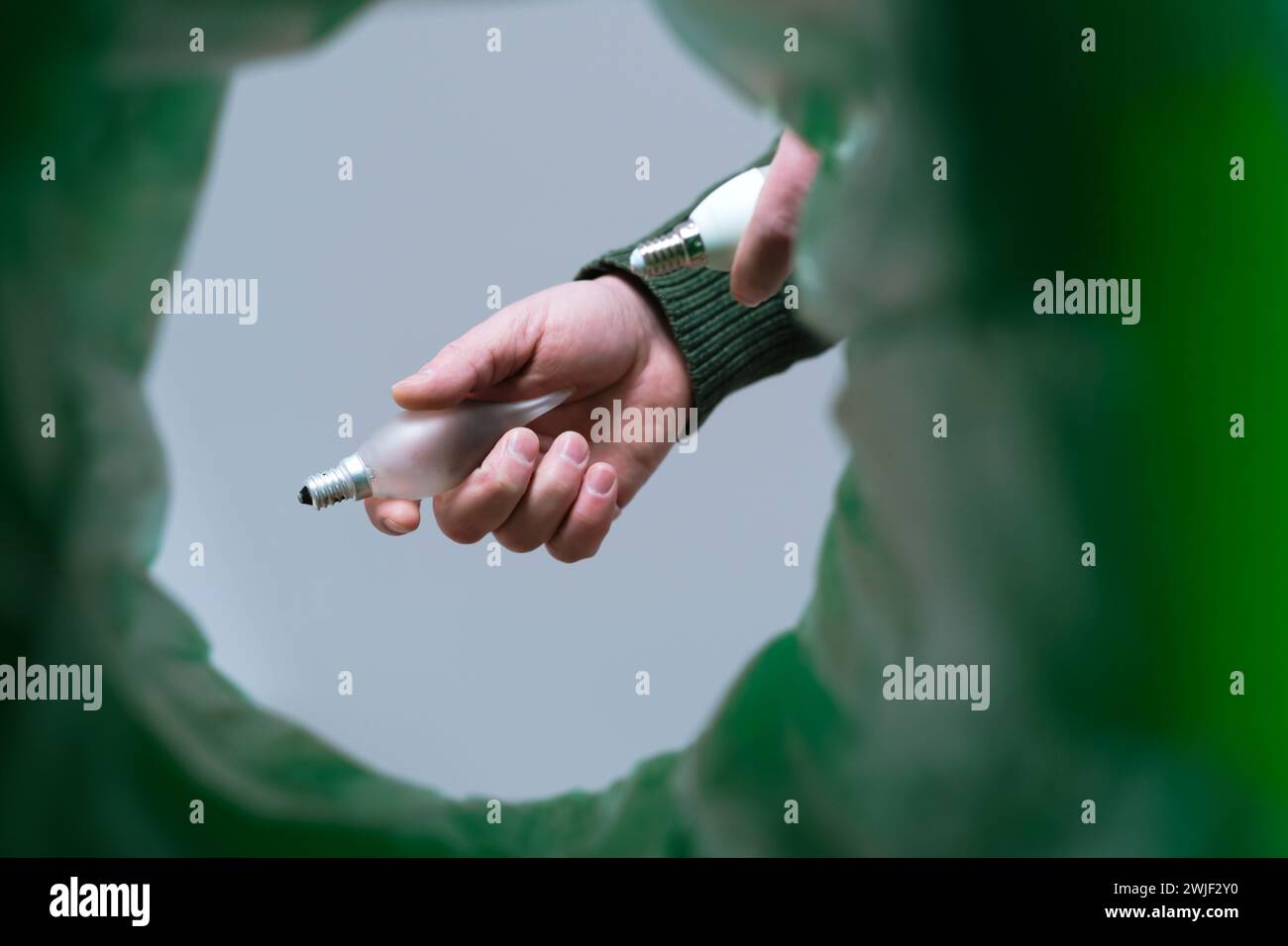 Low angle view hands male sorting plastic bottles in recycle bin in ...