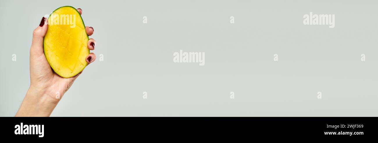 object photo of gourmet delicious mango in hand of young unknown woman ...