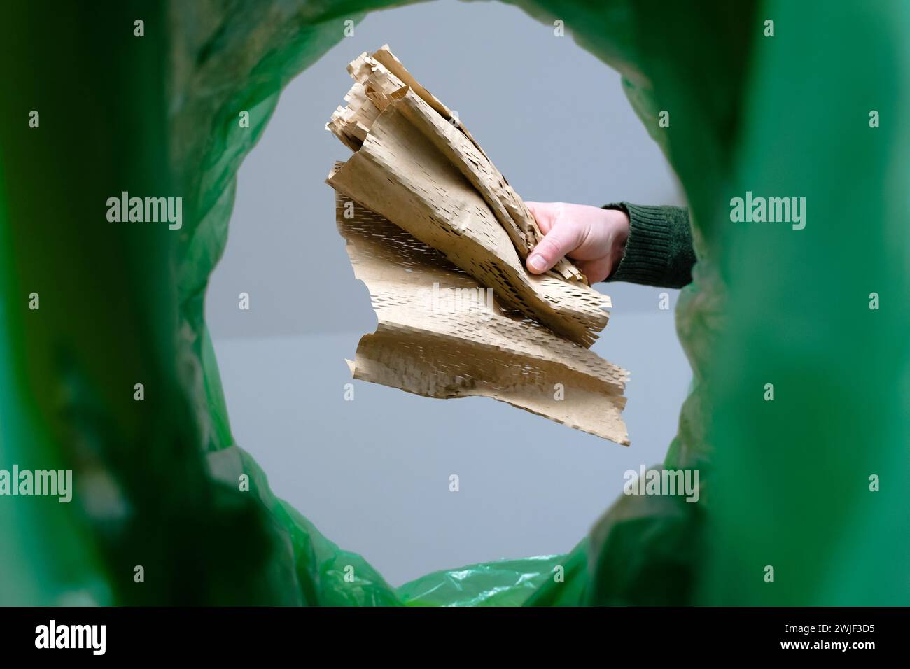 Low angle view male roll up kraft paper or gift packaging wrap in a ...