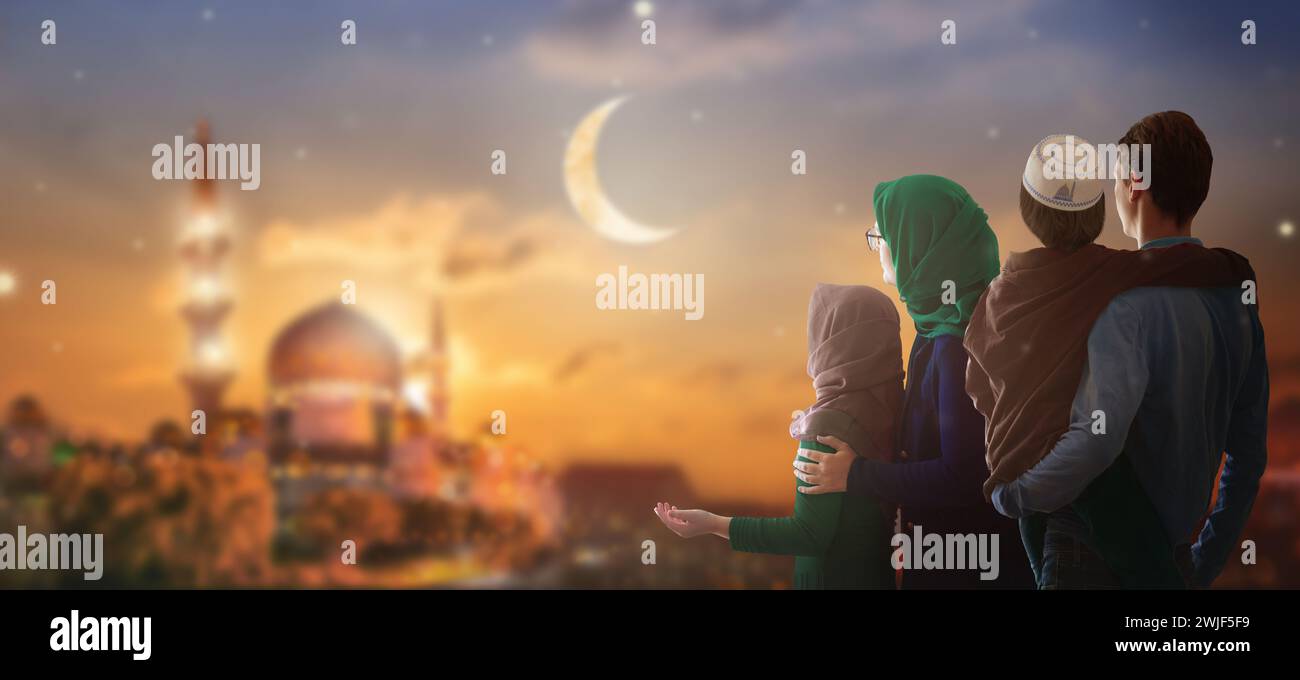 Ramadan Kareem greeting. Family at window looking at Islamic city with ...