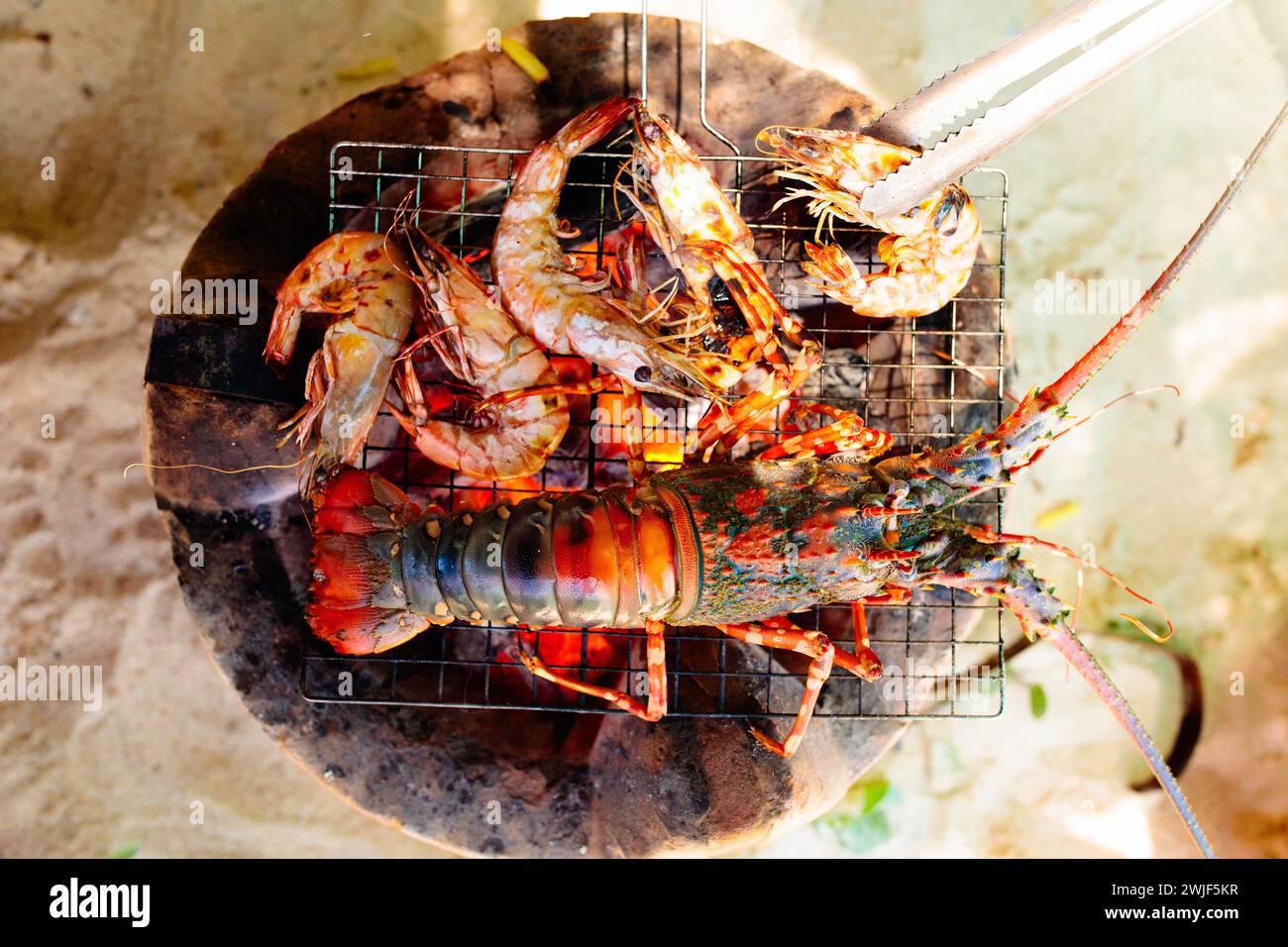 Seafood grill on the beach. Lobster, prawns and fish BBQ. Healthy lunch ...