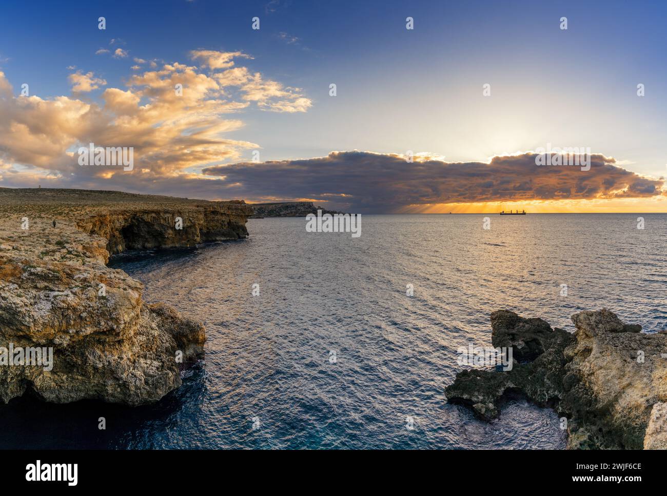 A sunset seascape in Malta with the Popeye Cliffs and a view of the ...