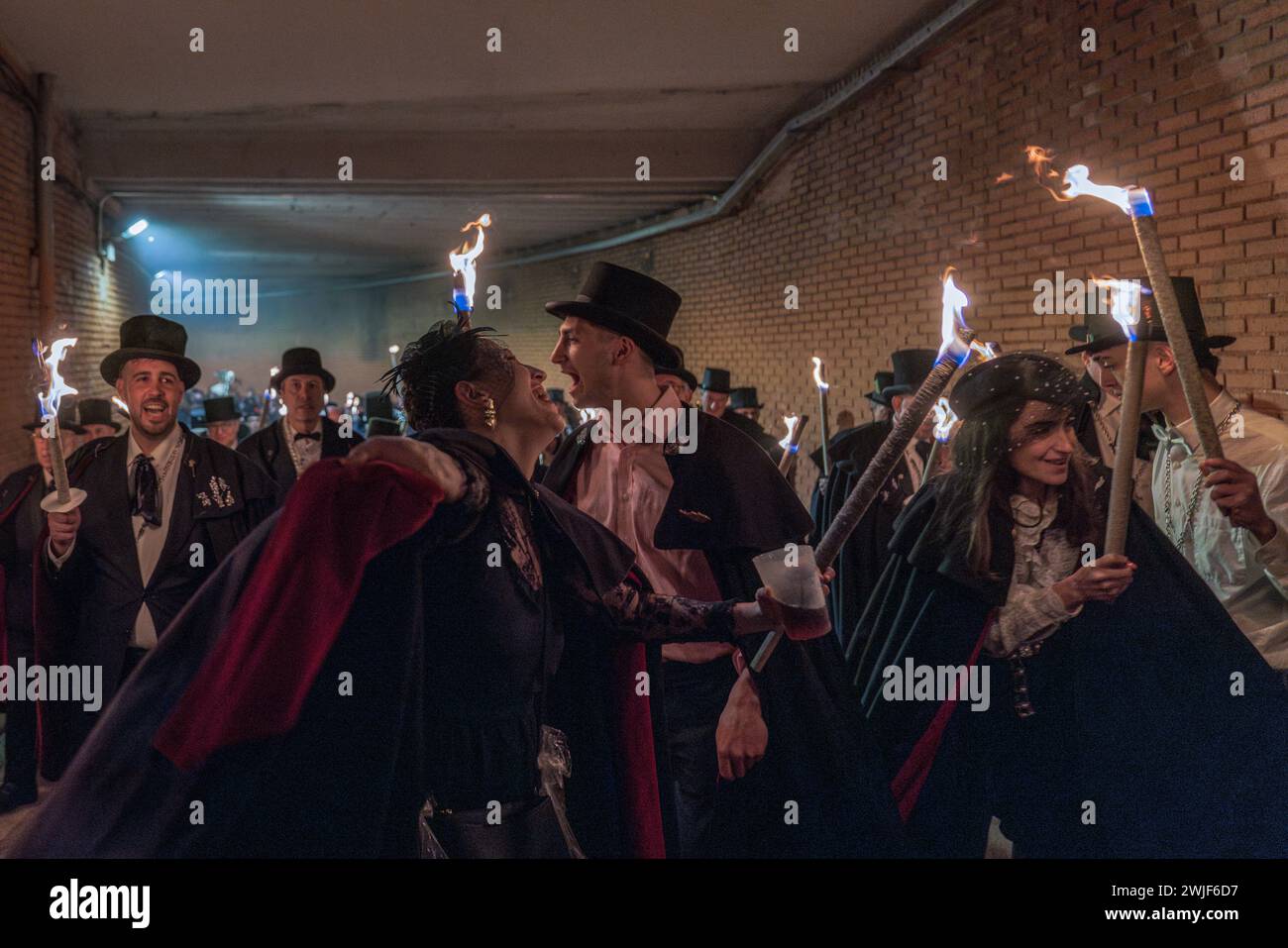 Members of the brotherhood of the sardine are seen carrying torches ...