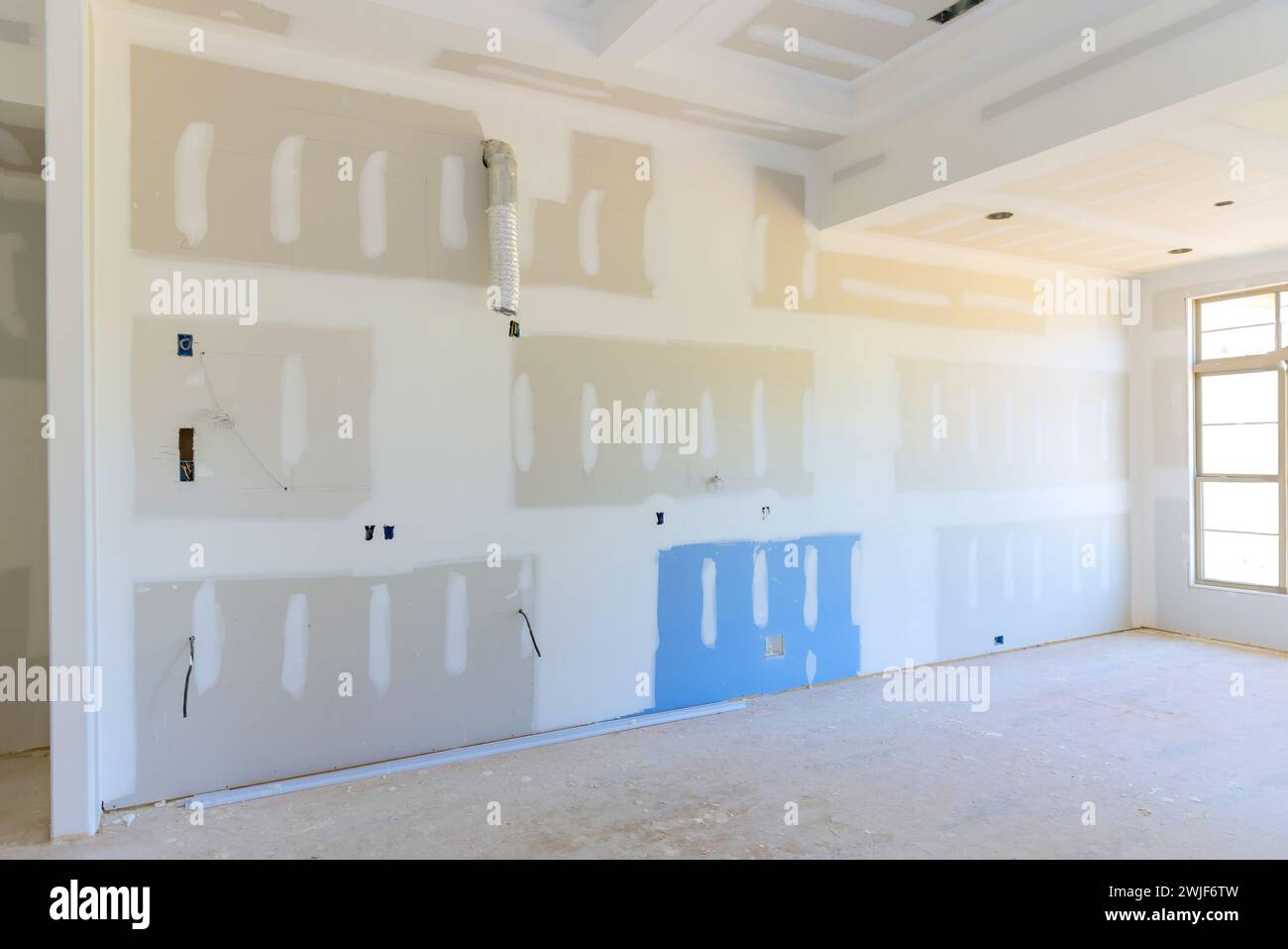 Construction site is being prepared for painting after plastering drywalling have been completed ...