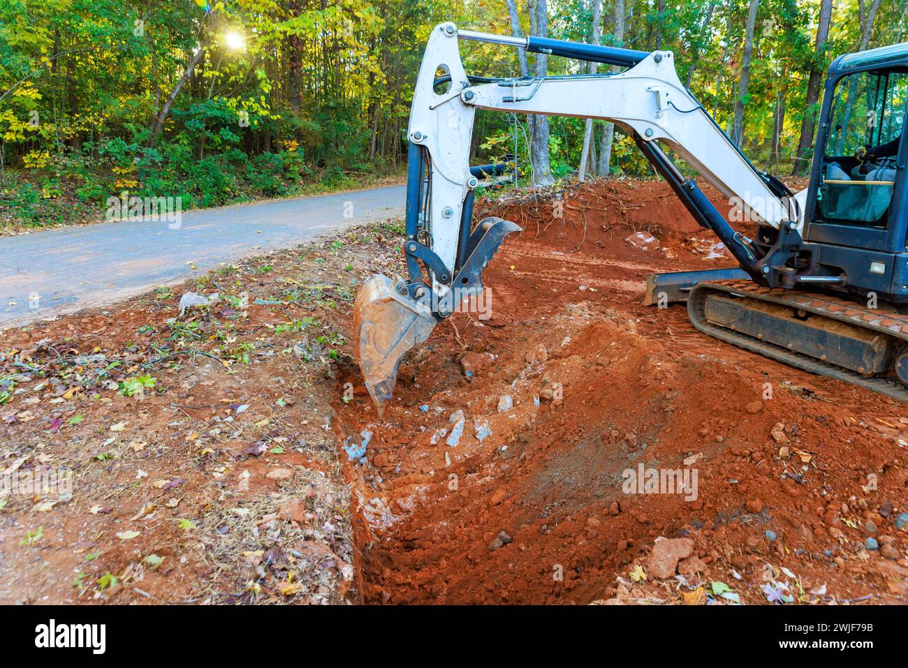 Excavator dig trenches for laying pipes to transport rainwater to ...