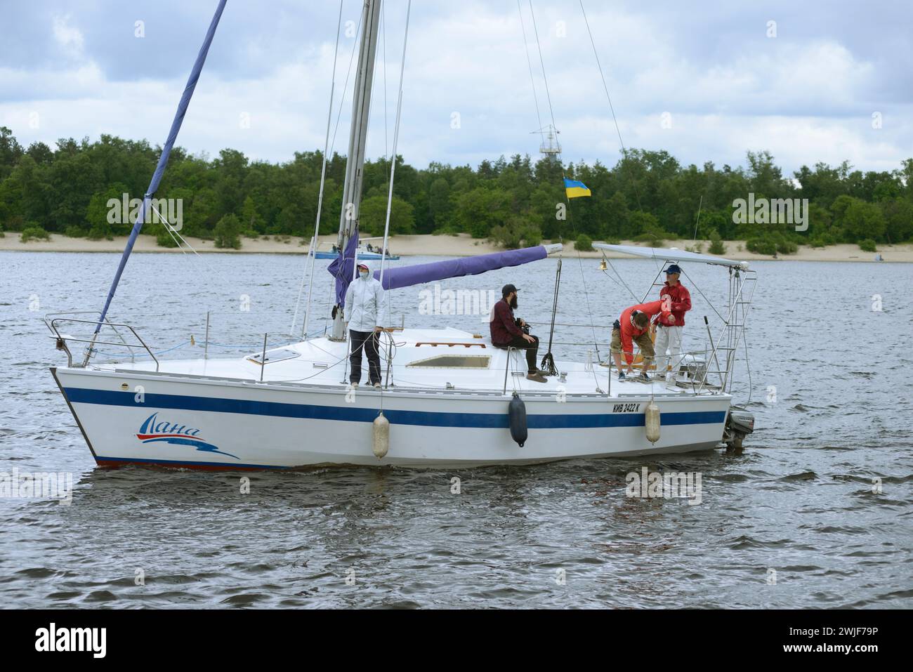 Crew of sailing yacht yachtsmen conducting a flanking maneuver. Amateur ...