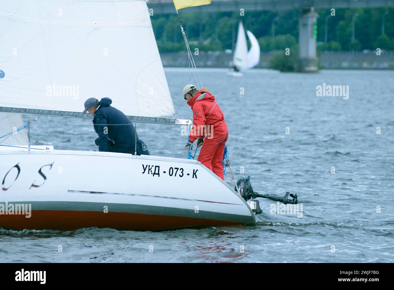 Crew of sailing yacht yachtsmen conducting a flanking maneuver. Amateur ...