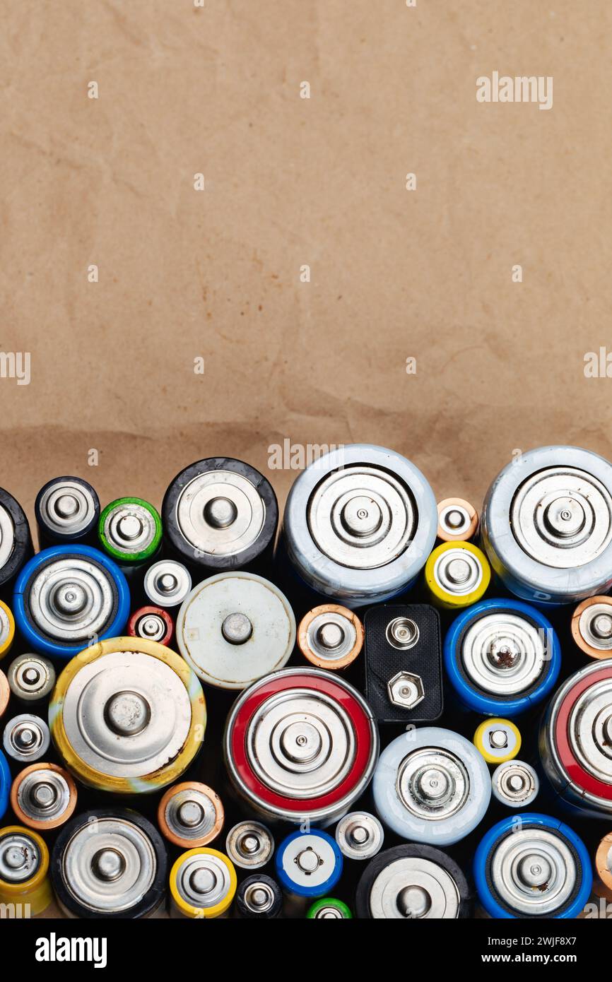 Top view of various used disposable alkaline batteries showcasing a mix ...