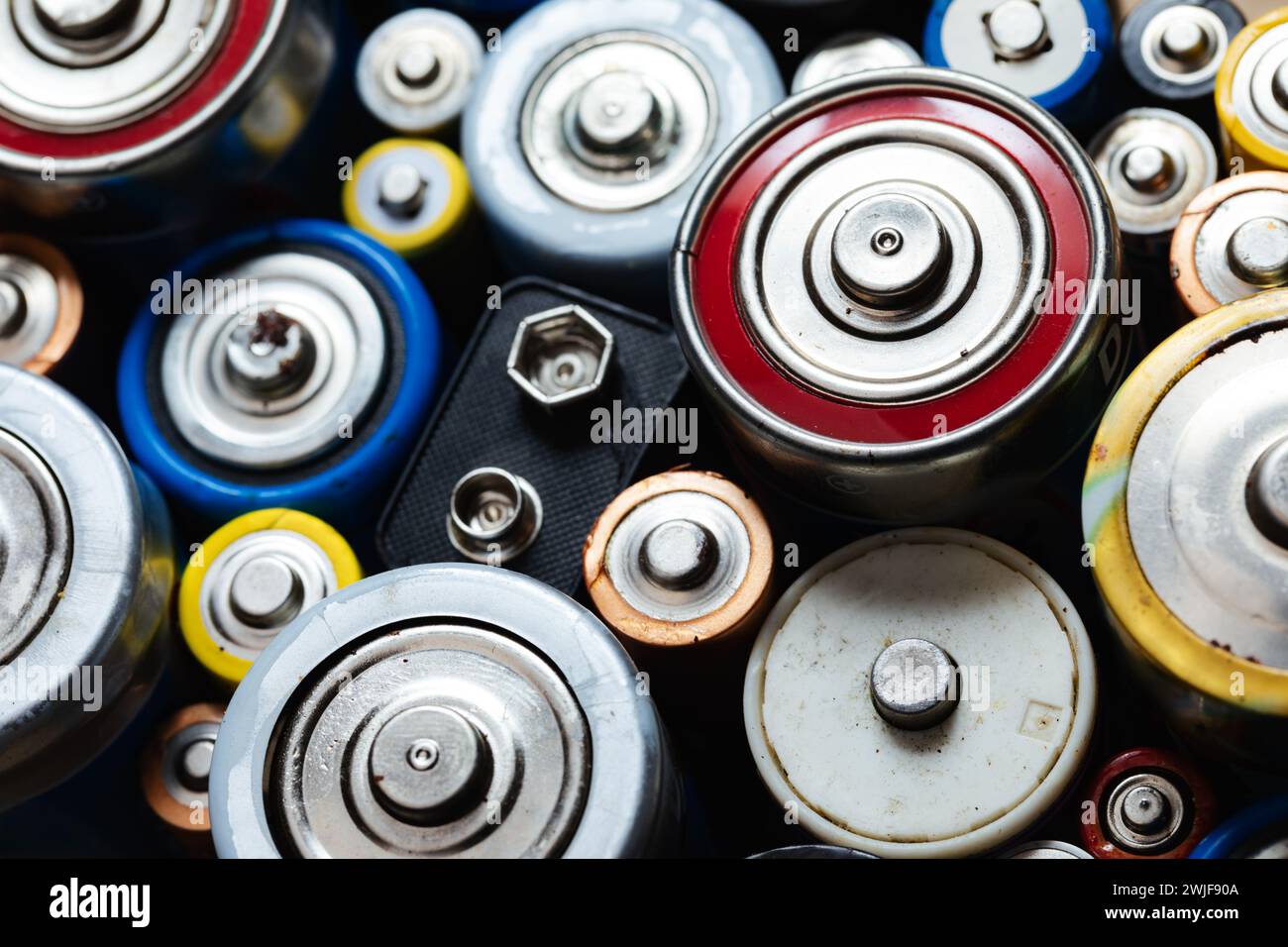 Close-up view of various used disposable alkaline batteries showcasing ...