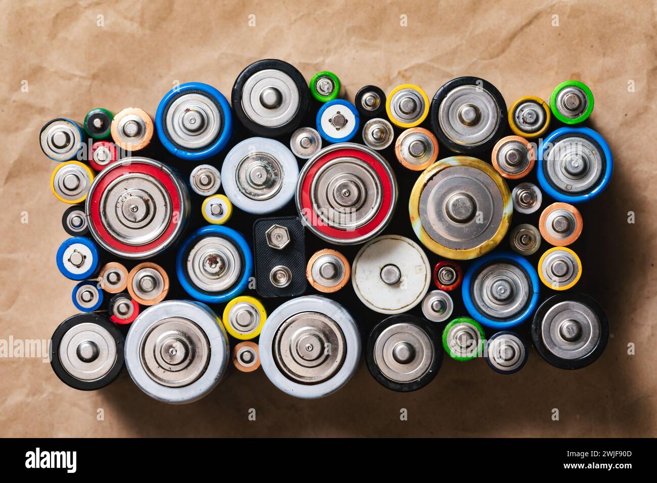 Top view of various used disposable alkaline batteries showcasing a mix ...