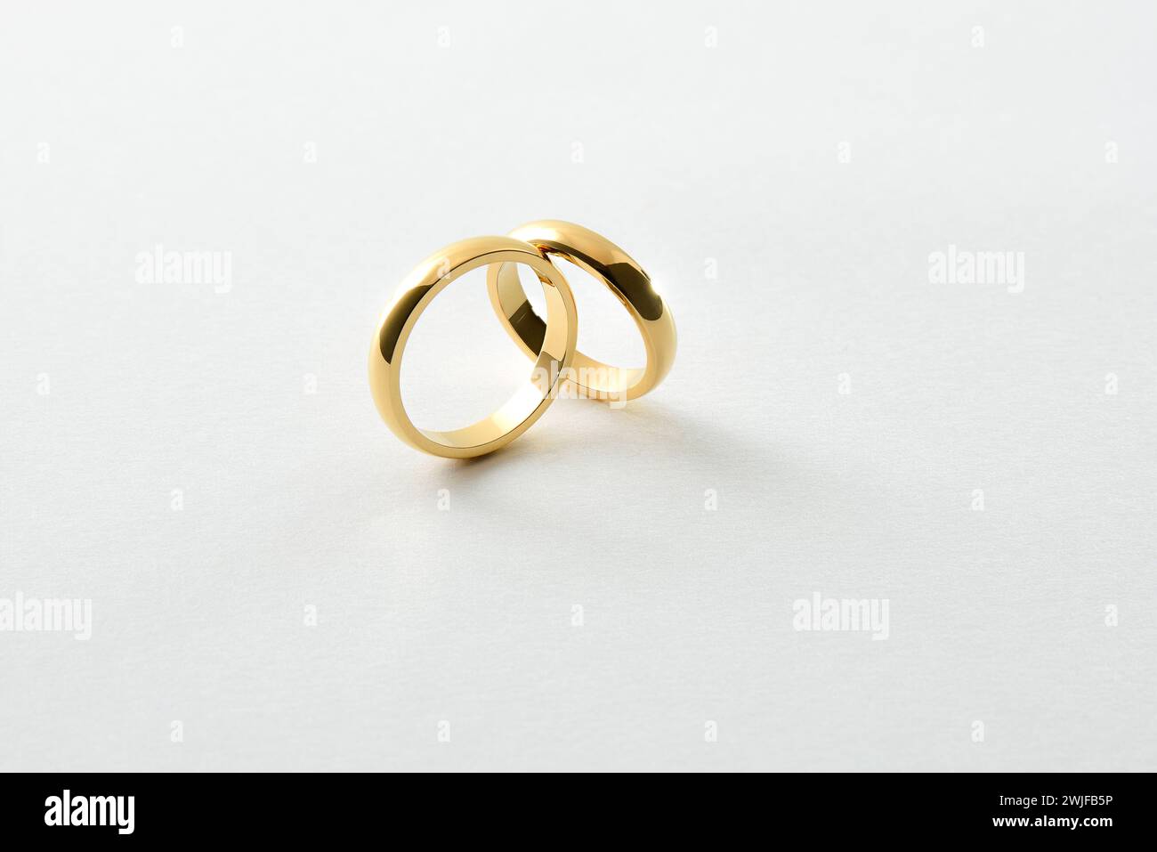 Detail of engagement gold rings standing one on the other isolated on ...