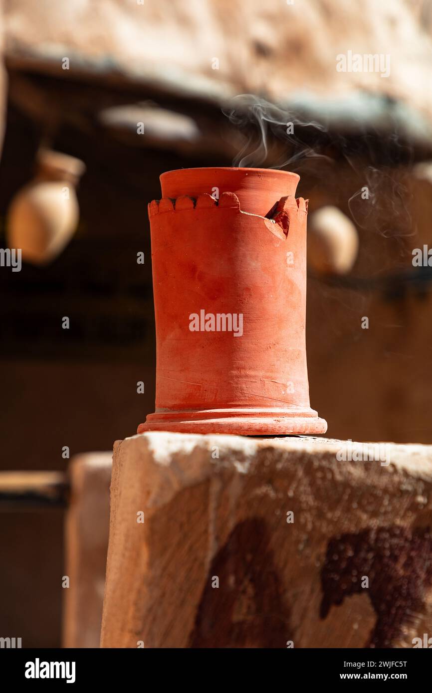 Incense burning in ceramic incense burner at arabic souk in Oman. Close ...