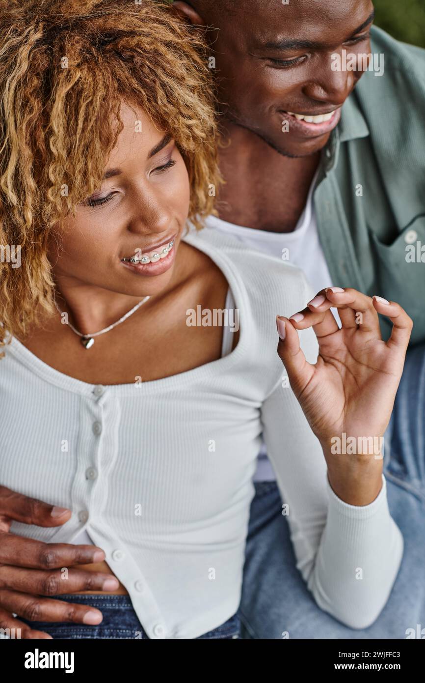 positive african american woman in braces using sign language for ...