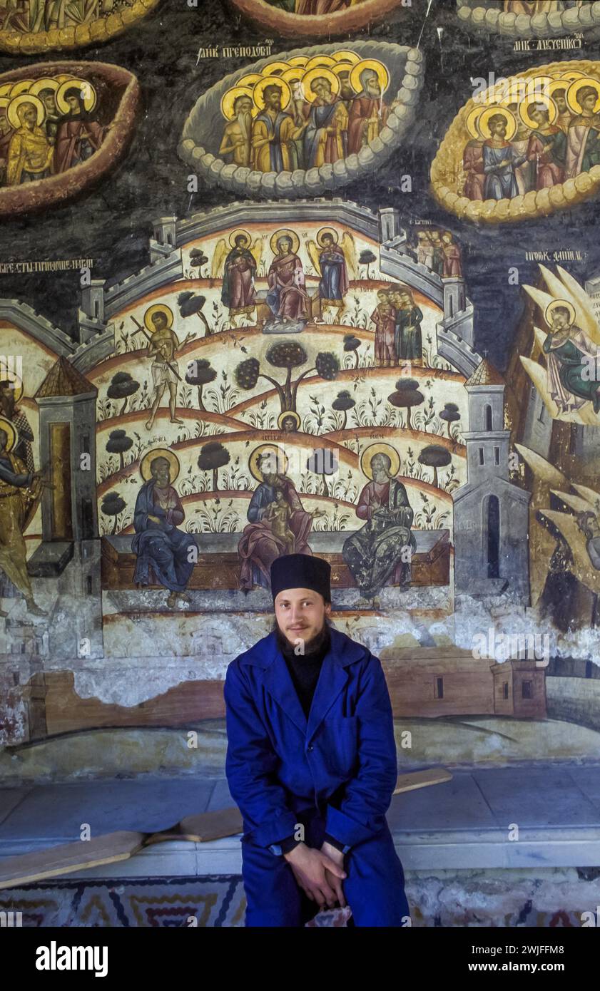 Romania, Cozia, priest in orthodox church with mural painting Stock ...