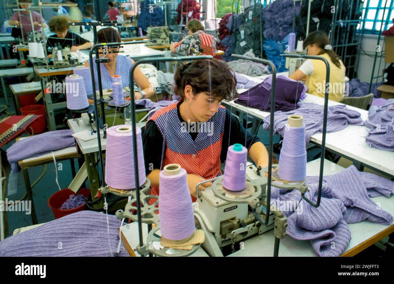 Romania, Bucarest. Female employees at a knitting machine Stock Photo ...