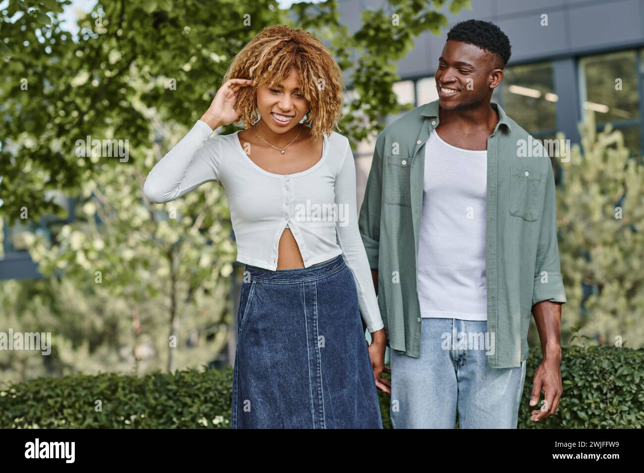 happy african american couple holding hands and walking together ...