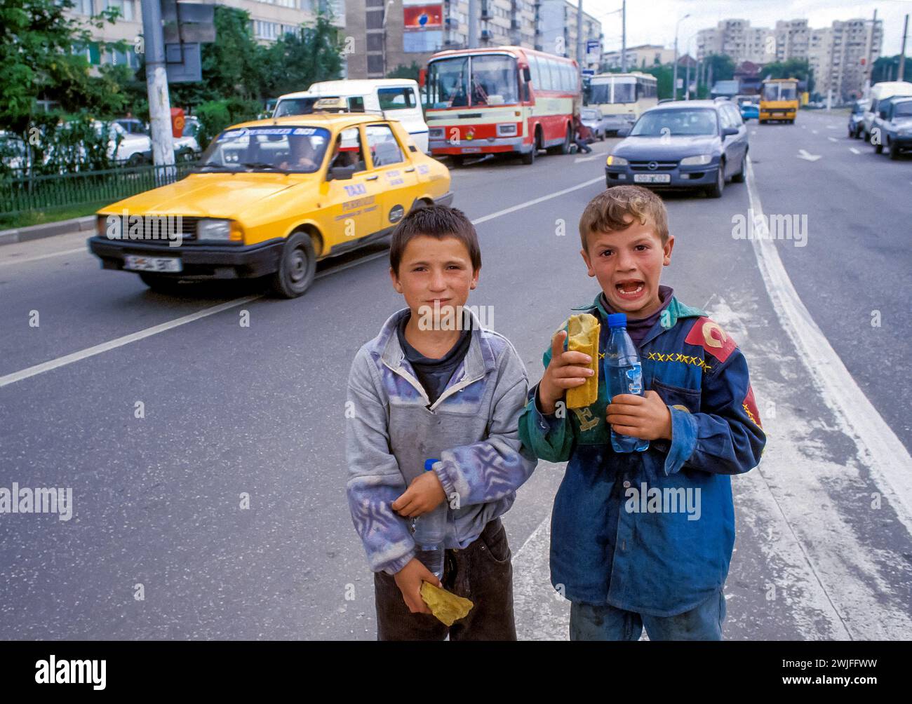 Romania, Bucharest. homeless boys wash cars at the traffic light Stock ...