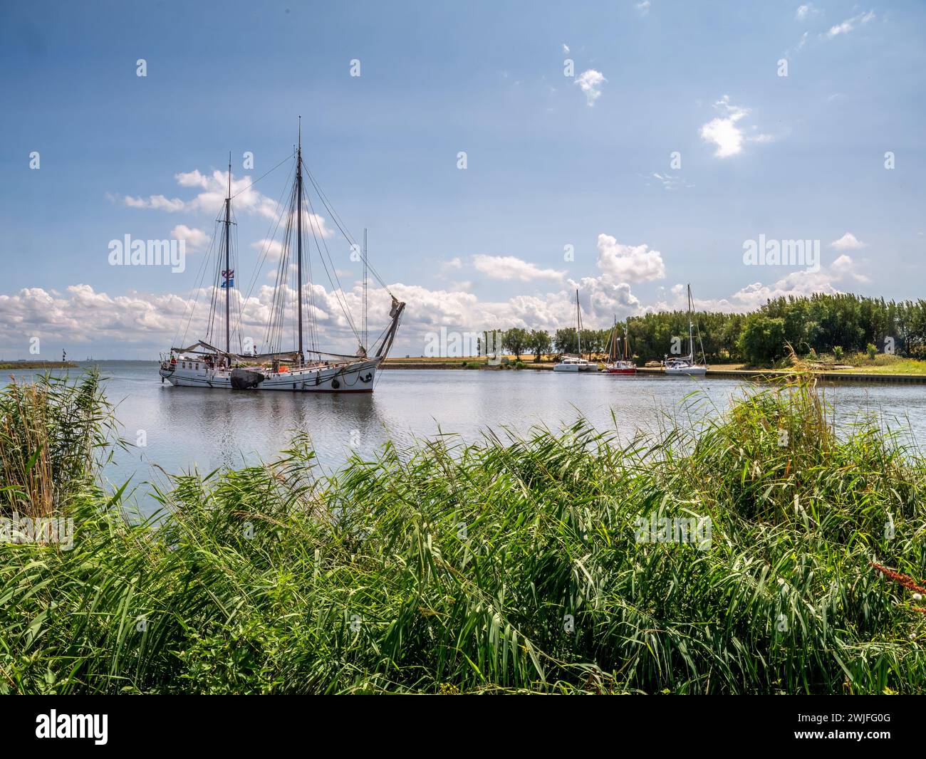 Two-masted sailing ship entering harbour of refuge Trintelhaven on ...