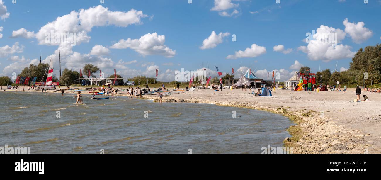 Panorama of people enjoying the beach of IJsselmeer lake in Makkum ...