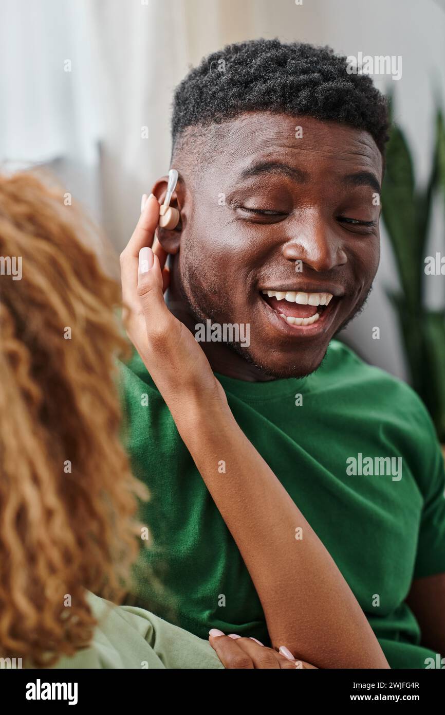 african american woman wearing hearing aid medical device on ear of ...