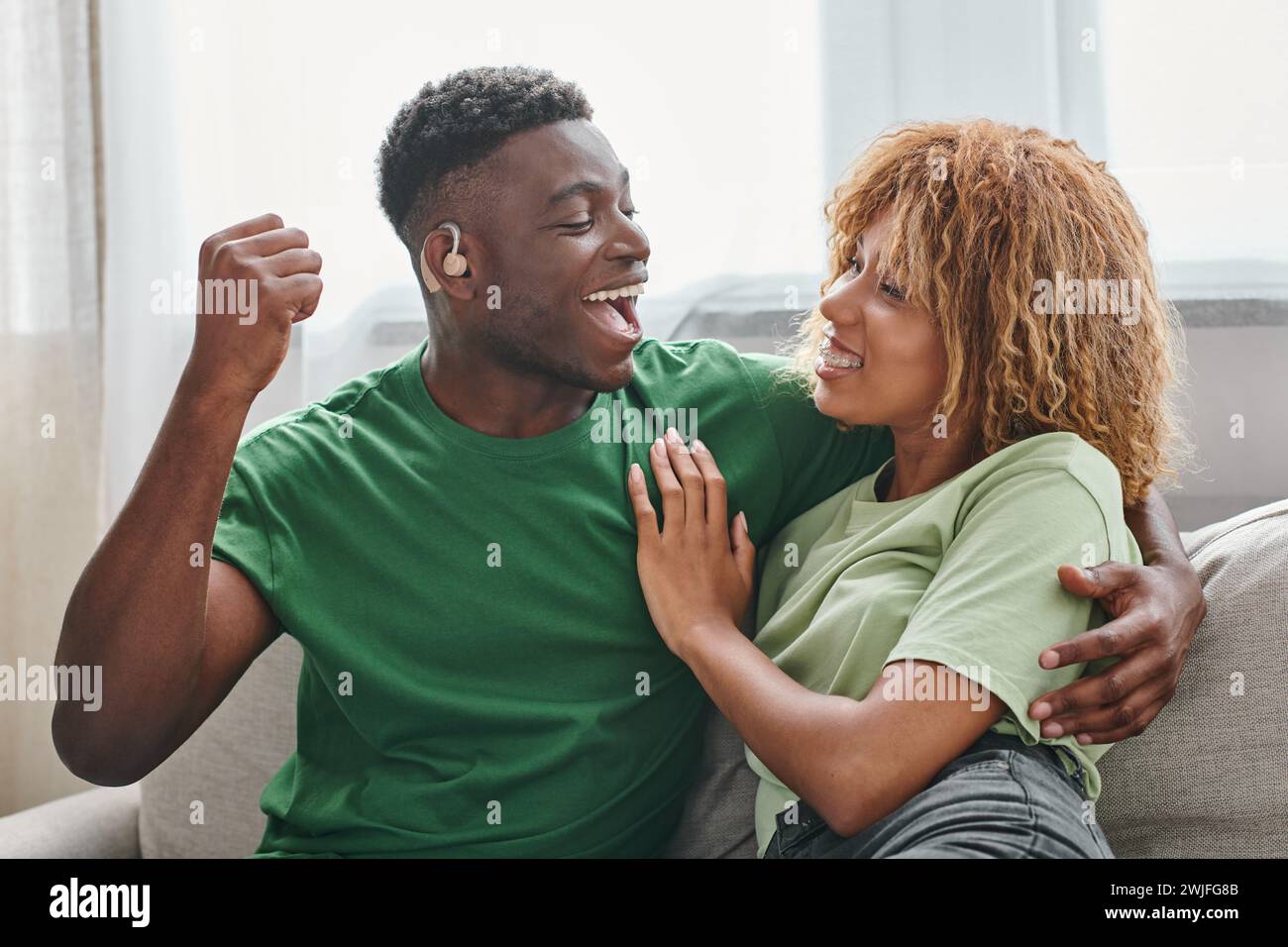 excited african american couple embracing, deaf black man in hearing ...