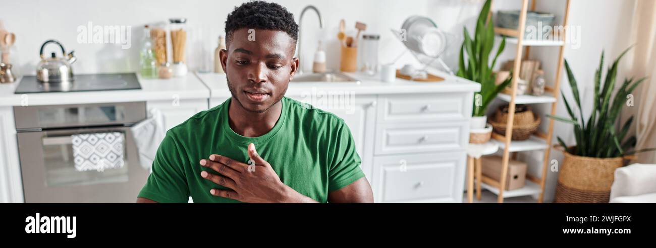 african american man in green t-shirt using sign language for online ...