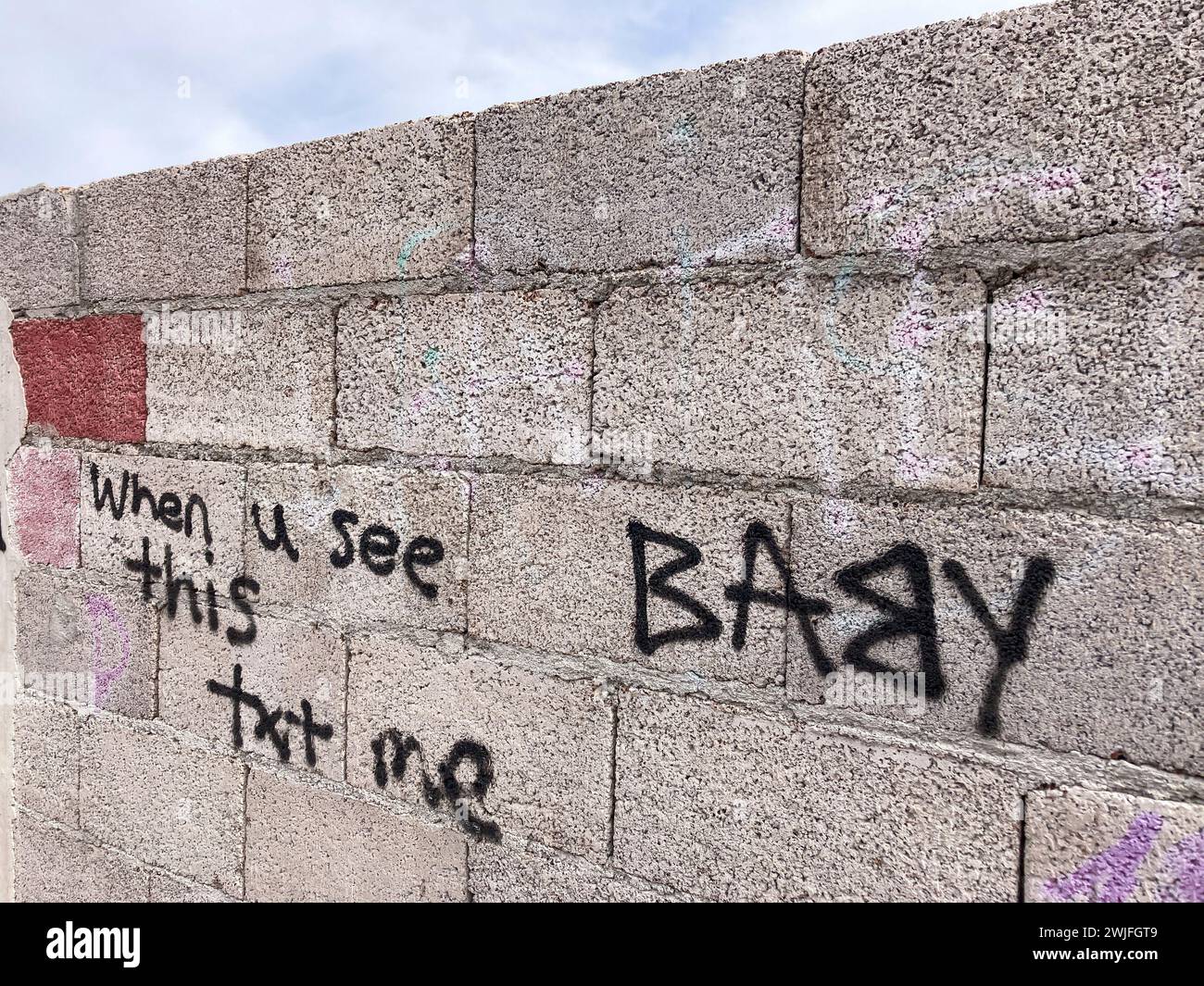 When u see this text me graffiti on a wall. Personal message written as ...